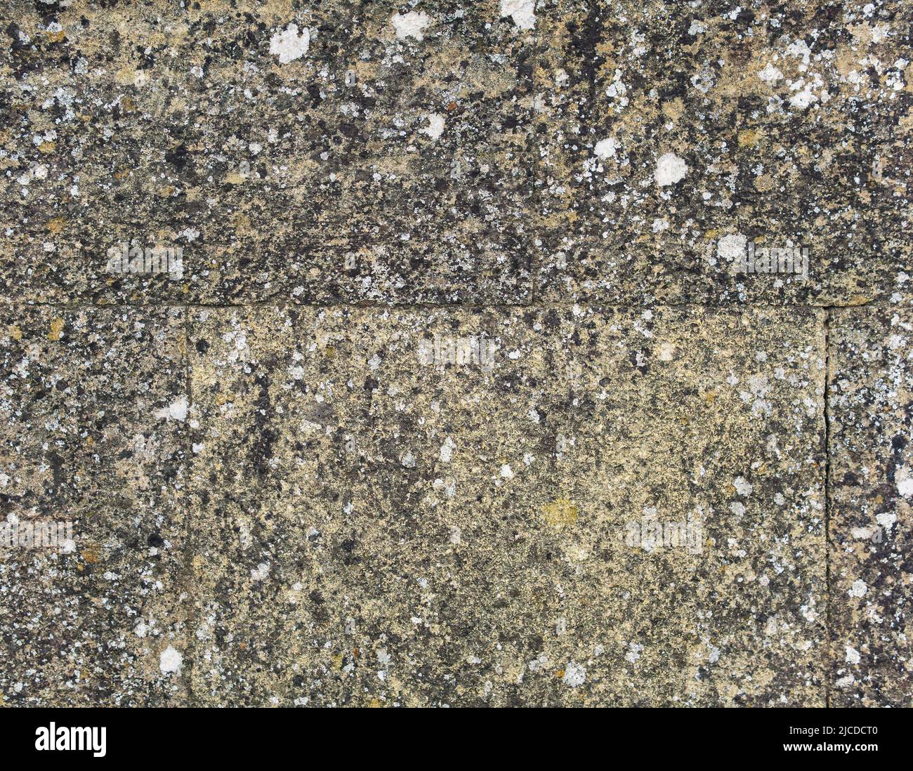 background, texture - a wall of even rough stone blocks, covered with ...