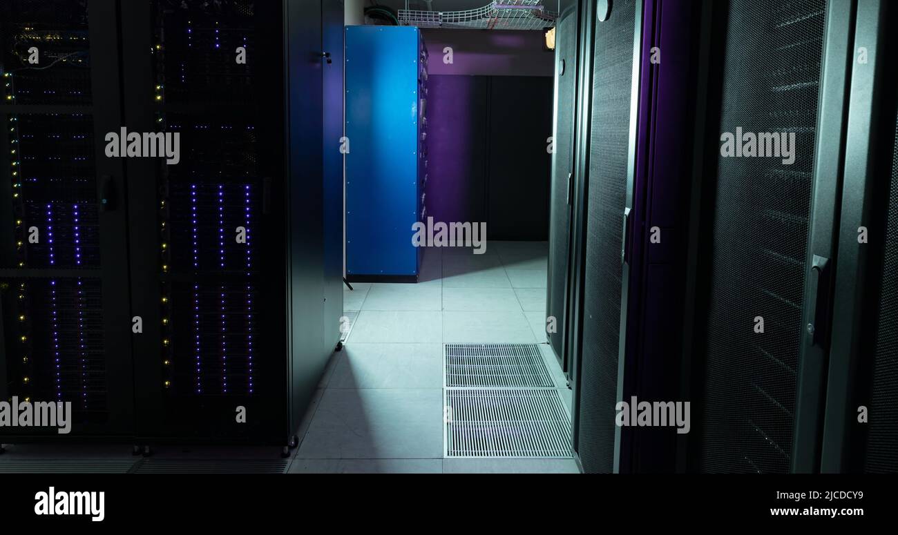 Image of empty corridor with rows of purple and blue computer servers ...