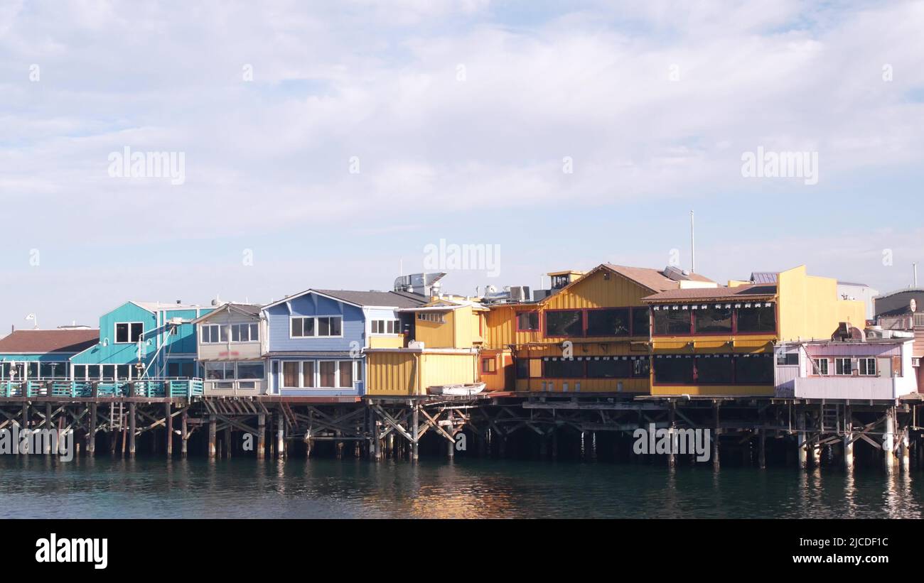 Colorful wooden houses on piles, pillars or pylons, ocean sea water ...