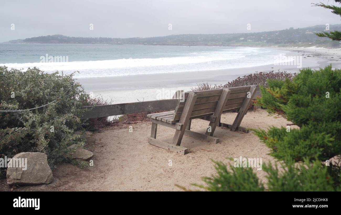 Empty wooden bench, rest on trail path, walkway or footpath. Carmel ...