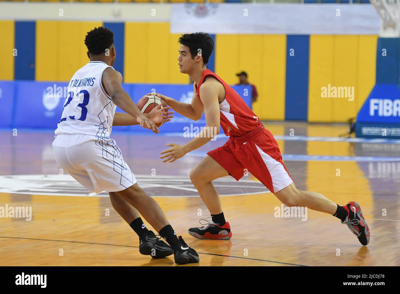 Doha, Qatar. 12th June, 2022. Talal F A H Mohammad (L) of Kuwait Basketball team and Kei Rooney ...