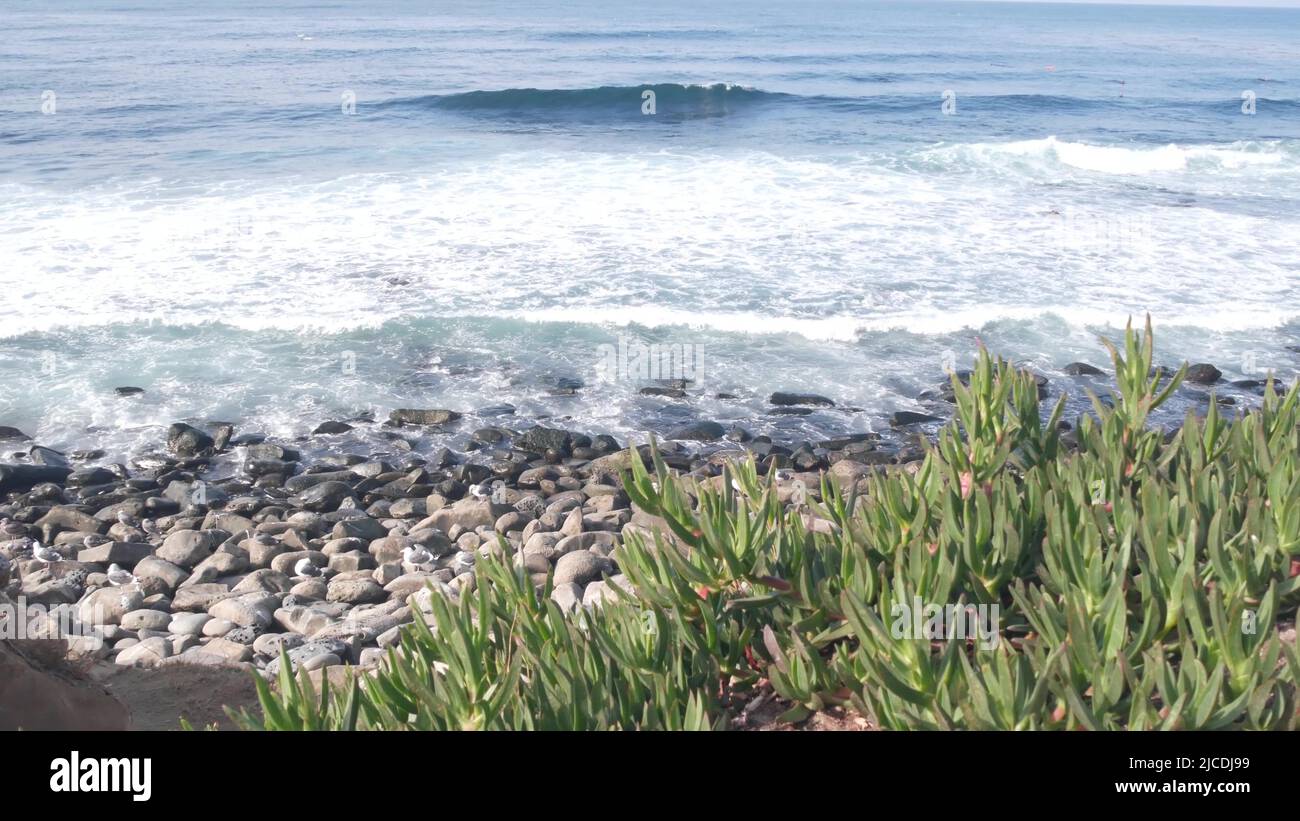 Ocean waves crashing on beach, sea water surface from above, cliff or ...