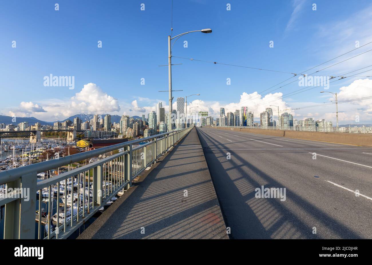 Pedestrian Sidewalk on Granville Bridge with Downtown City Buildings in ...