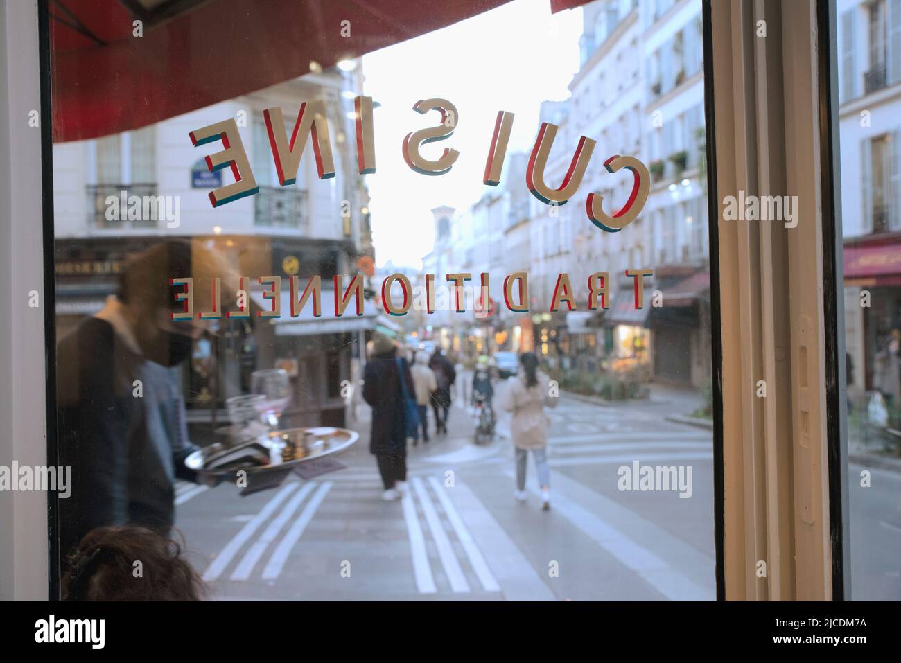 A view through the window of a French Café in Paris offering ...
