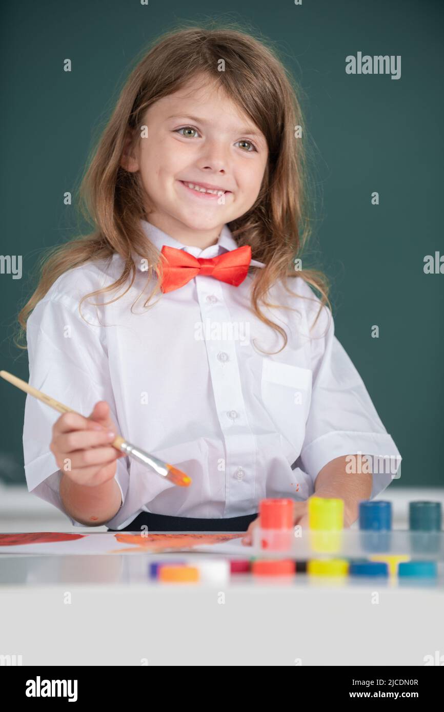 Portrait of little girl smiling happily while enjoying art and craft ...