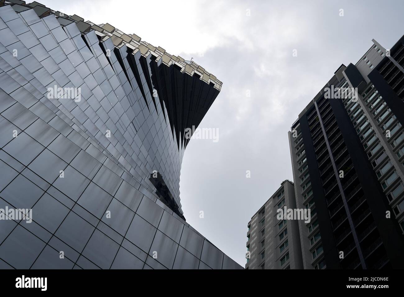 Upper part of a geometric skycraper in Bangkok Stock Photo - Alamy
