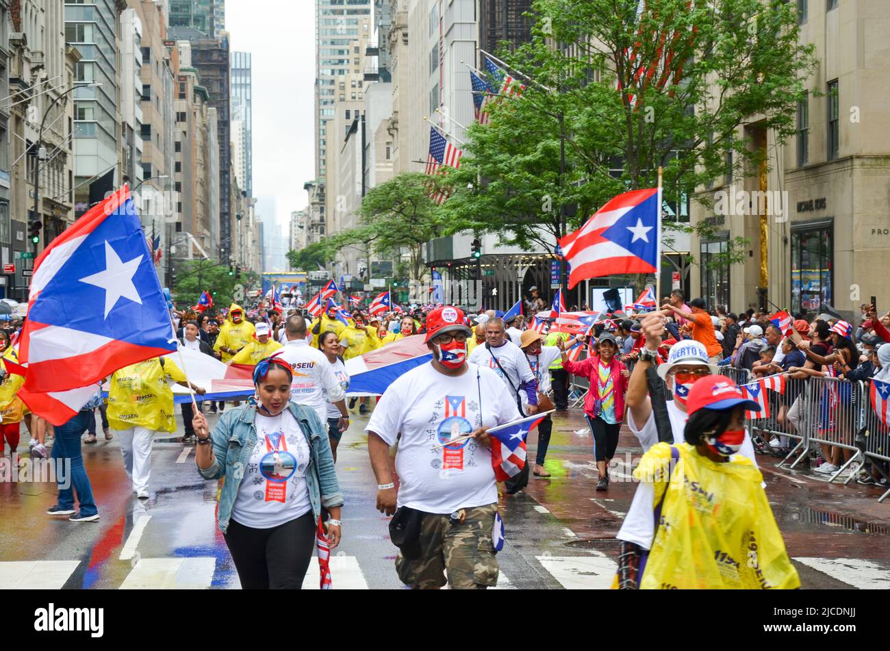 Puerto Rican New Yorkers are seen marching with flags through Fifth ...