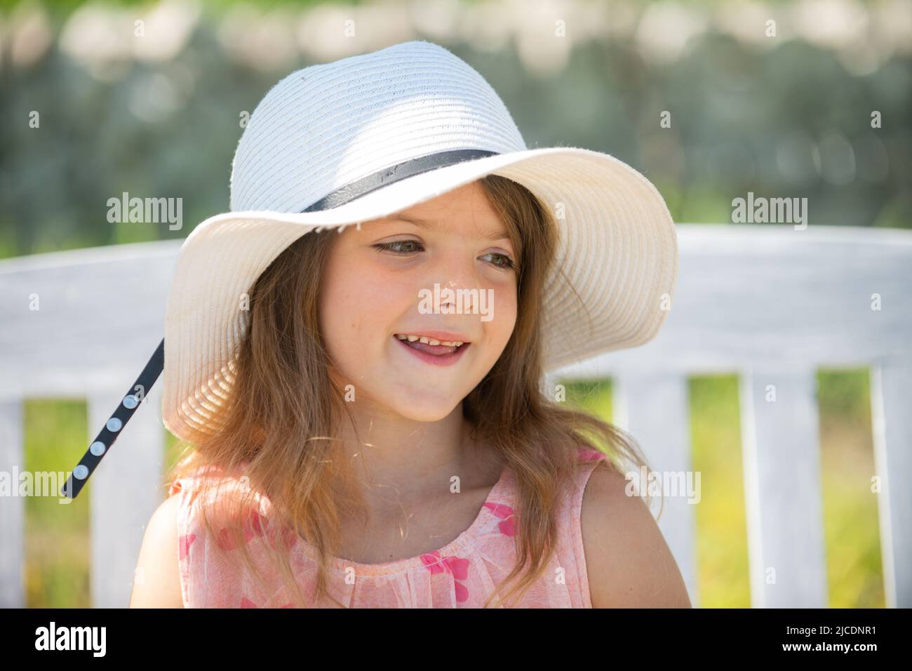 Spring kids girl outdoor, child cute face. Cute little girl swinging on ...