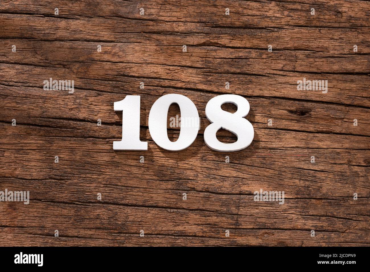 Number 108 in wood, isolated on rustic background Stock Photo - Alamy