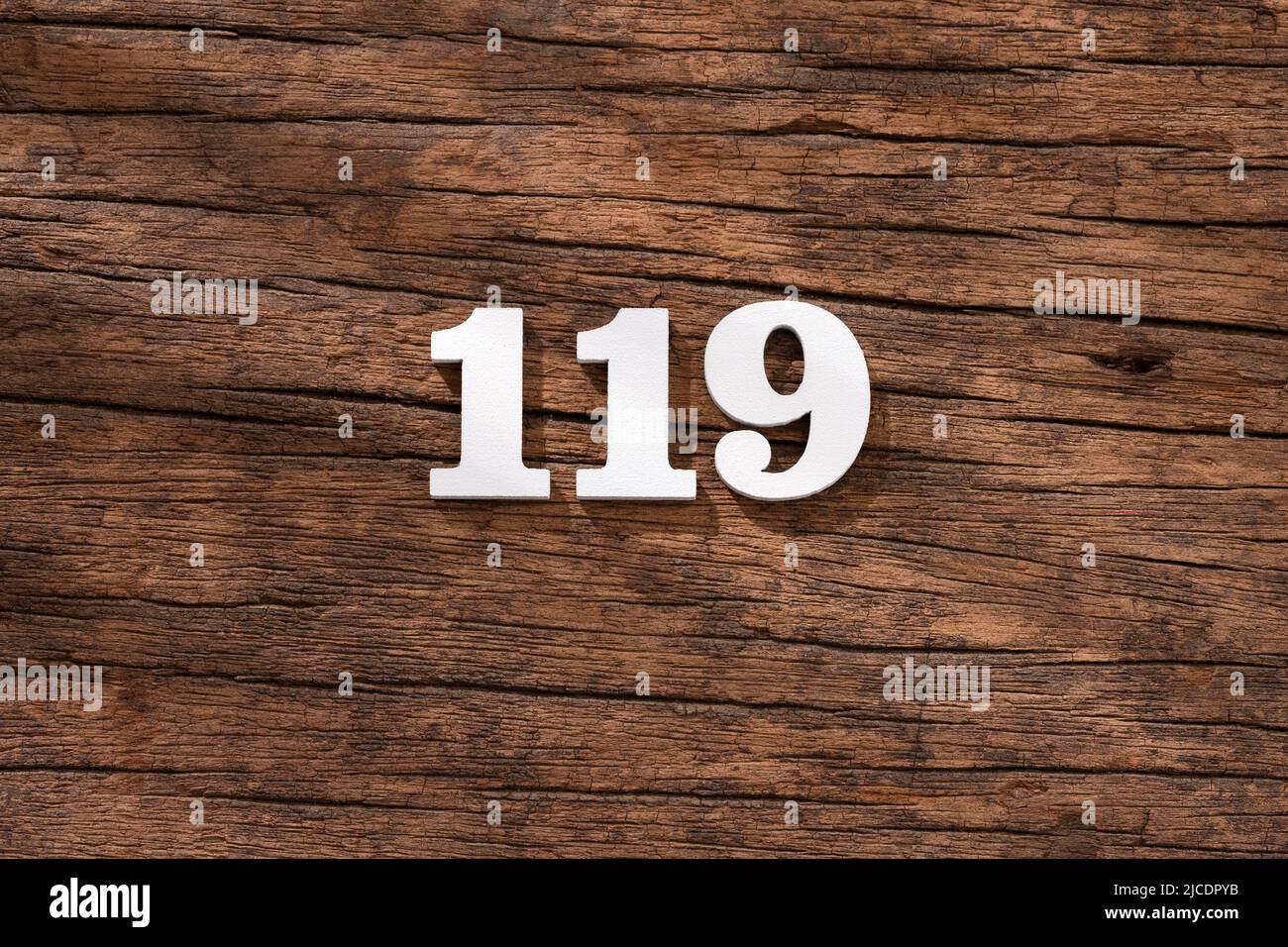 Number 119 - piece on rustic wood background Stock Photo - Alamy