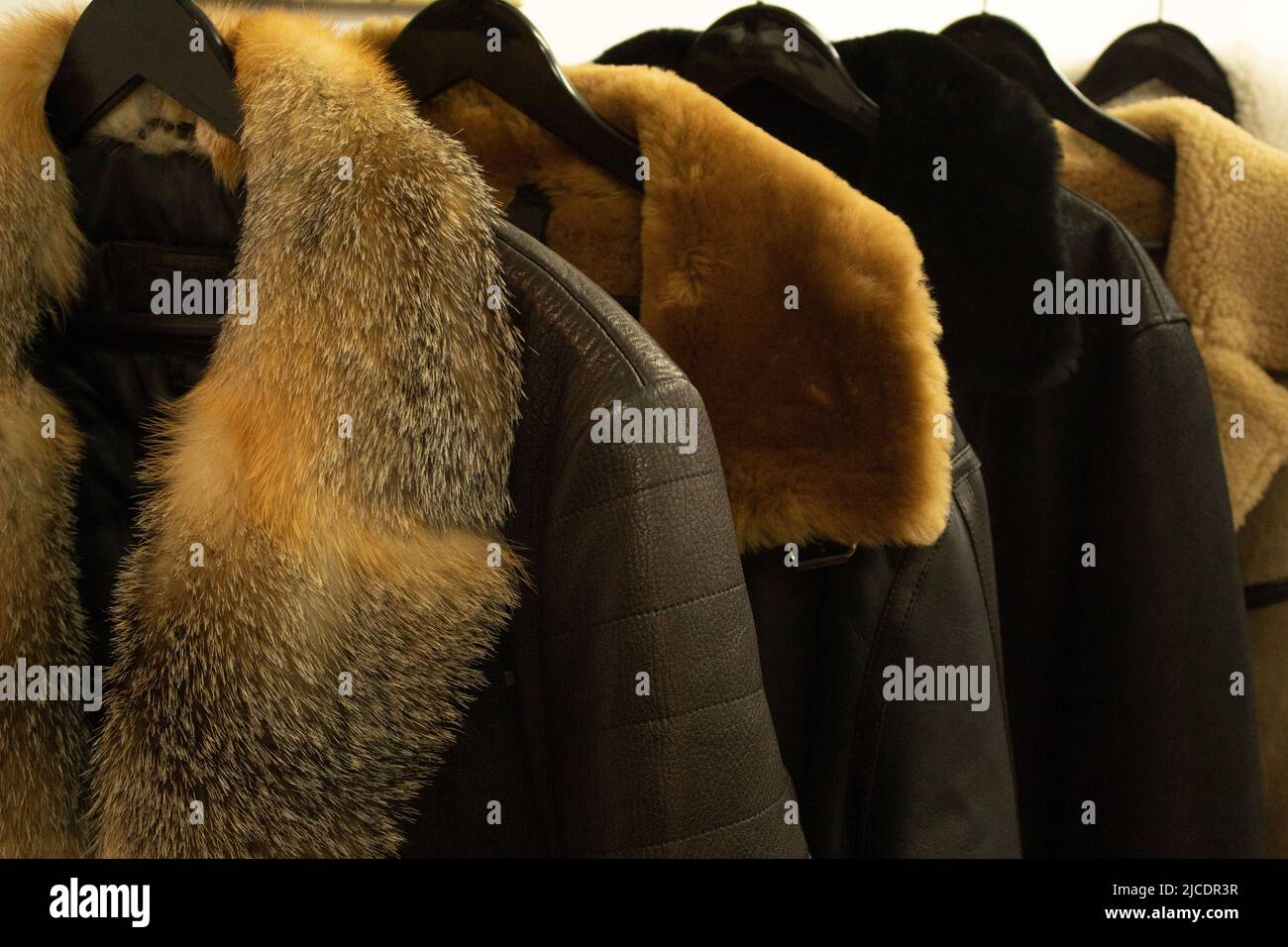 Collection of leather jackets on hangers in the shop. Many new men's ...