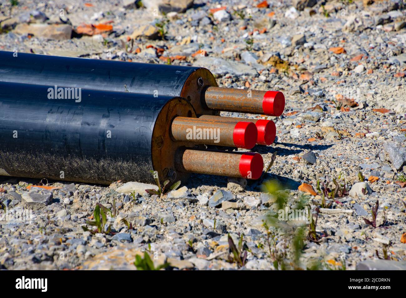 Black insulated district heating pipe laying on a construction site ...