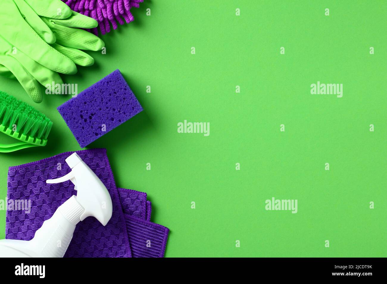 Flat lay house cleaning items and supplies on green background. Flat ...