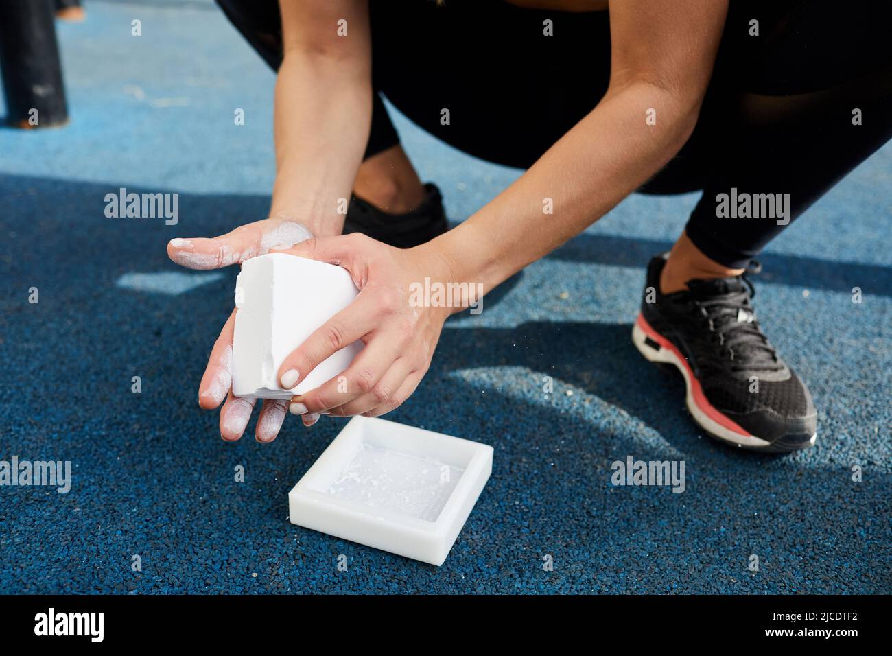 Close-up of unrecognizable woman crouching down and using gymnastic ...