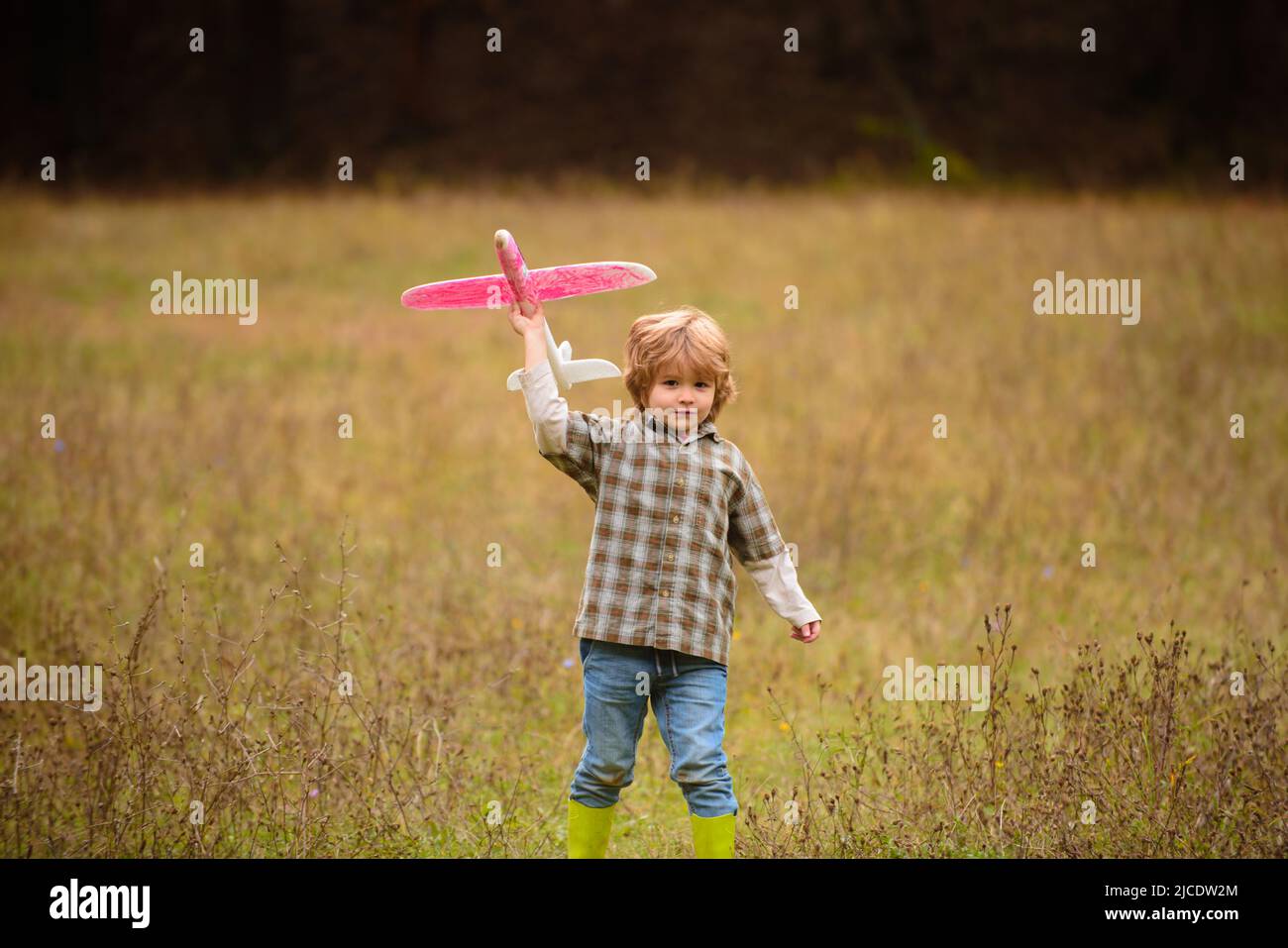 Funny child or kid little boy pilot play with toy airplane, startup ...
