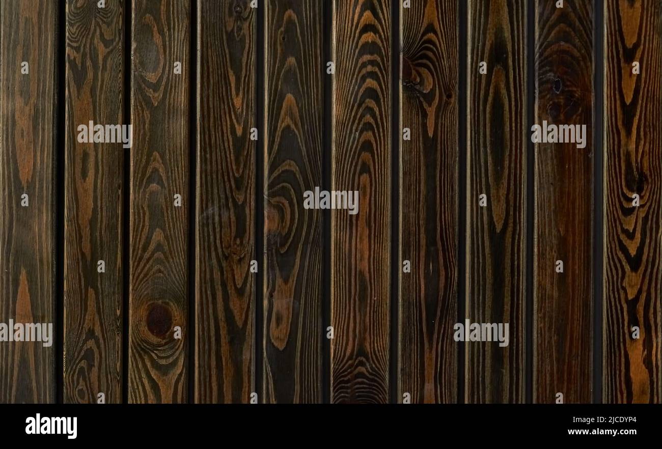 The texture of a wooden shield made of boards impregnated with stain, a ...