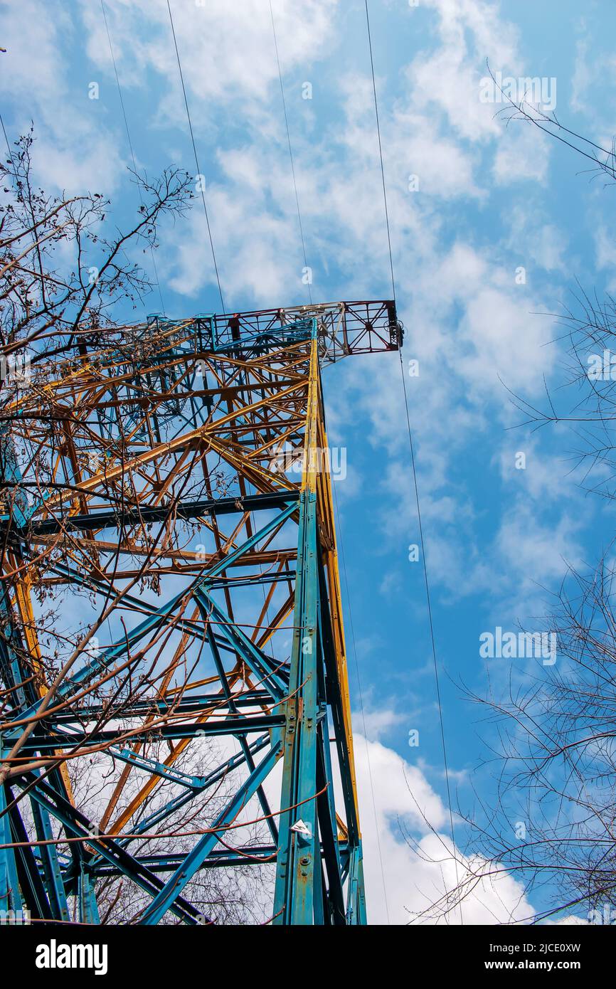 Close-up view of an electric tower with a beautiful blue sky background ...