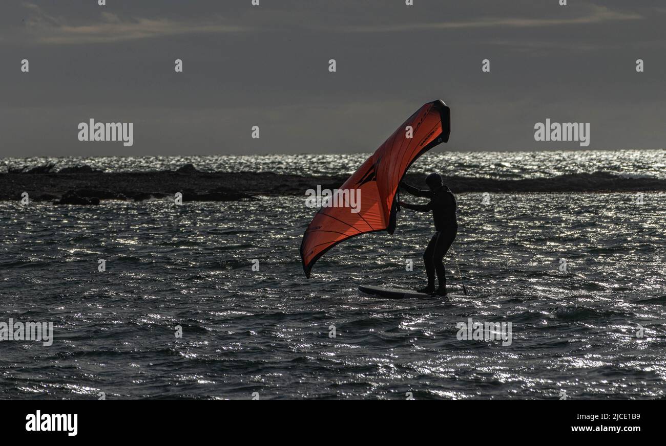 Surfboarder against the sun Stock Photo - Alamy