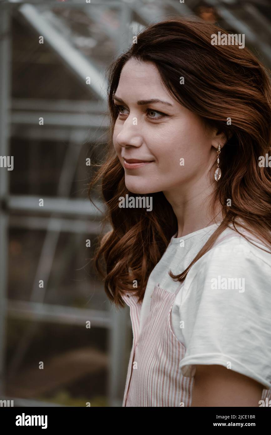 Pretty woman at her 30s in dark evening garden. Beautiful dreamlike ...