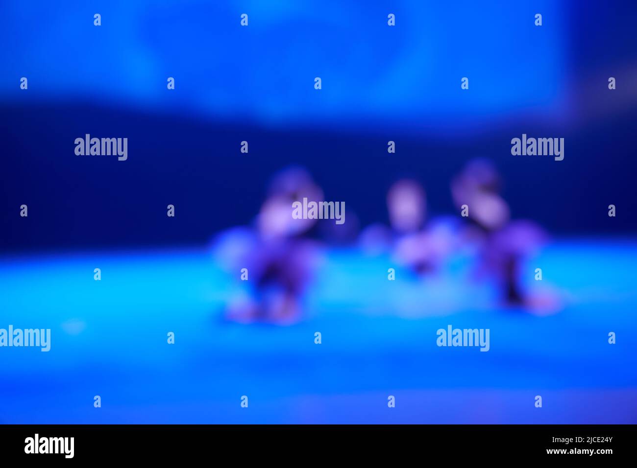 A blurry background of a dance festival from a group of little girls ...