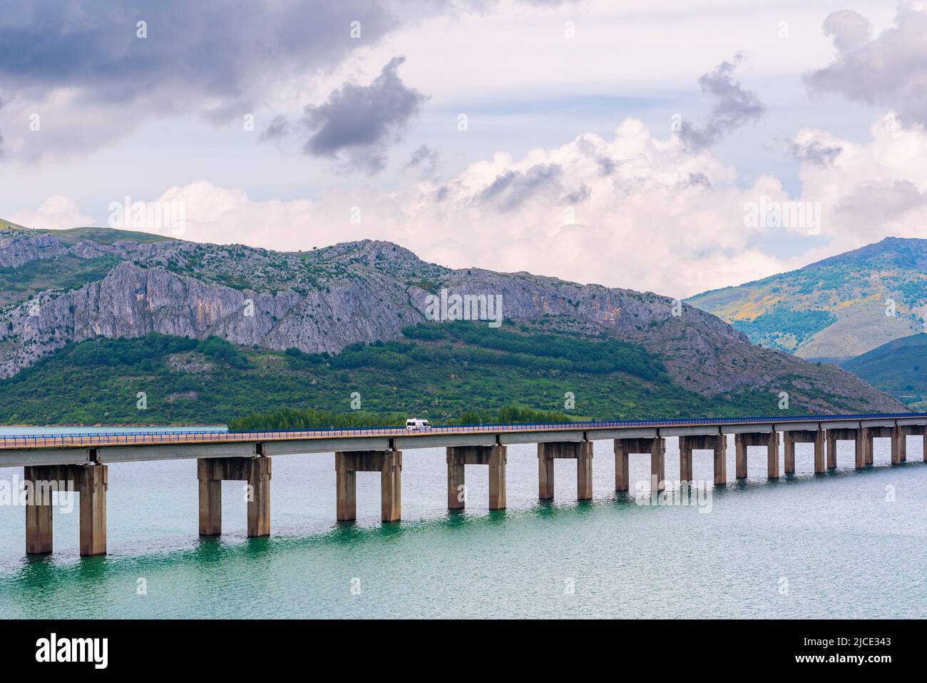 Camper circulating through the viaduct of the Riaño reservoir, Leon ...