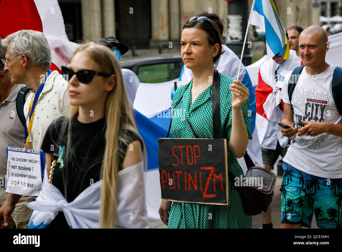 A protester holds an anti-war white-blue-white flag with blue-yellow ...