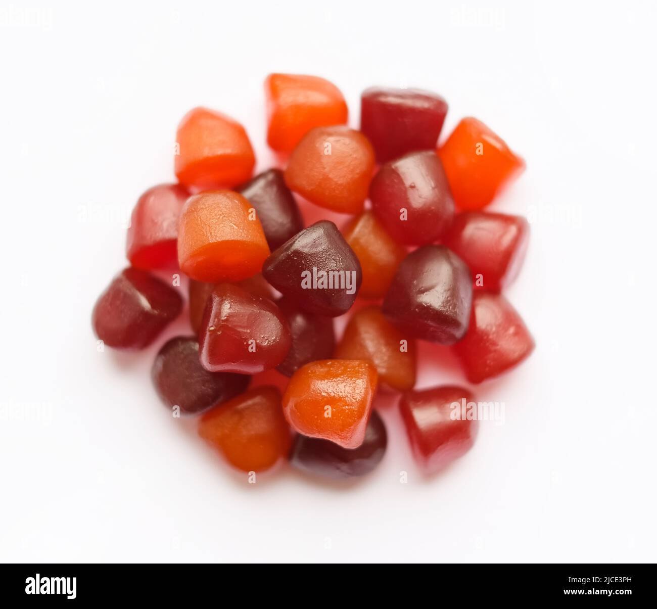 Group of red, orange and purple multivitamin gummies isolated on white ...