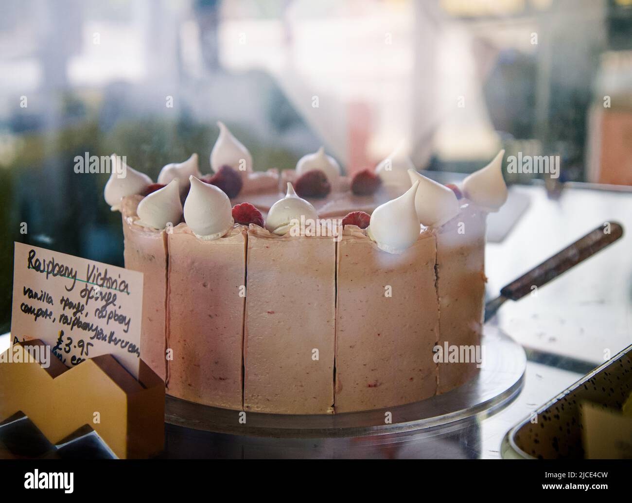iced vanilla sponge cake (victoria sponge) with meringues and fruit ...