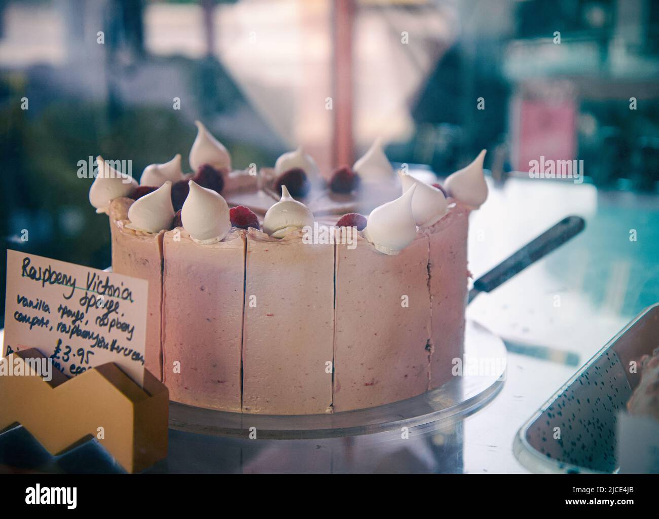 iced vanilla sponge cake (victoria sponge) with meringues and fruit ...