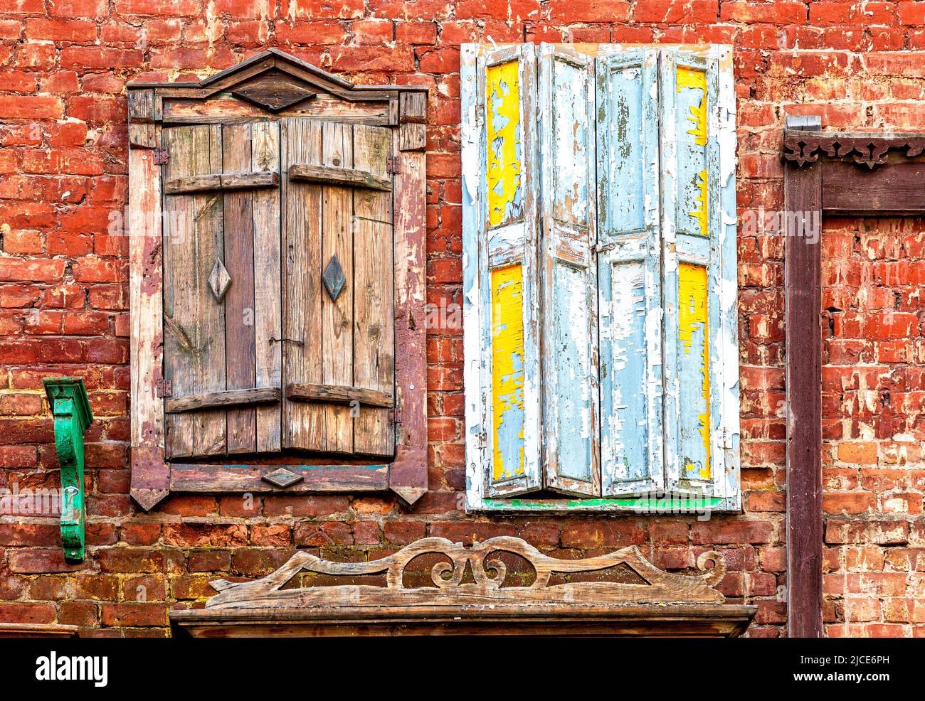 Old building brick wall with an window with hinged shutters. Windows of ...