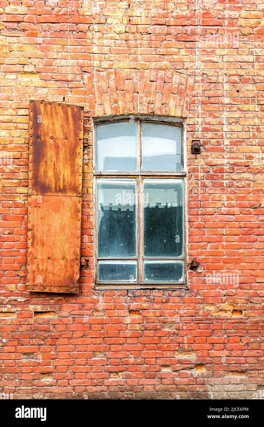 Old building brick wall with an window with hinged shutters. Windows of ...