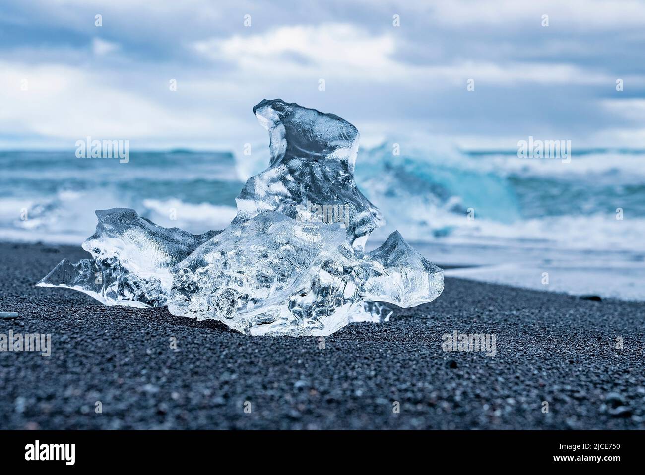 Close-up of beautiful iceberg chunk on black sand of Diamond beach ...