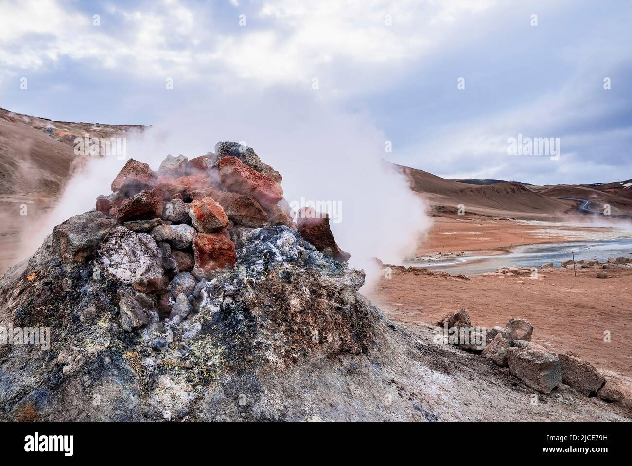 Steaming fumarole in geothermal area of Hverir at Namafjall against ...