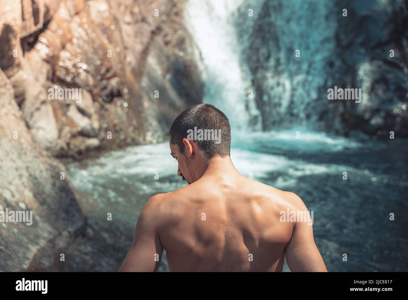 Summer background back shot of a male in front of crystal clear ...