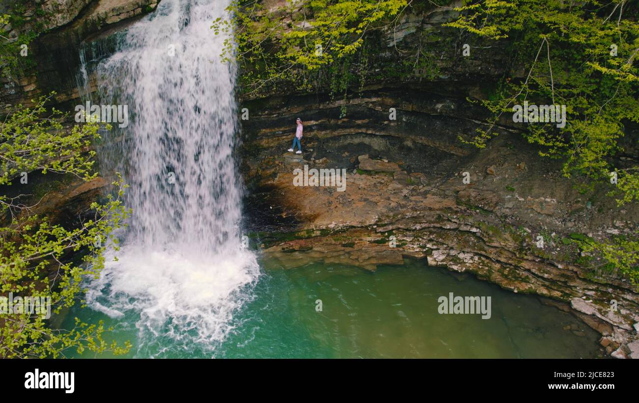 top-down view of a waterfall and s small green lake. High quality photo ...