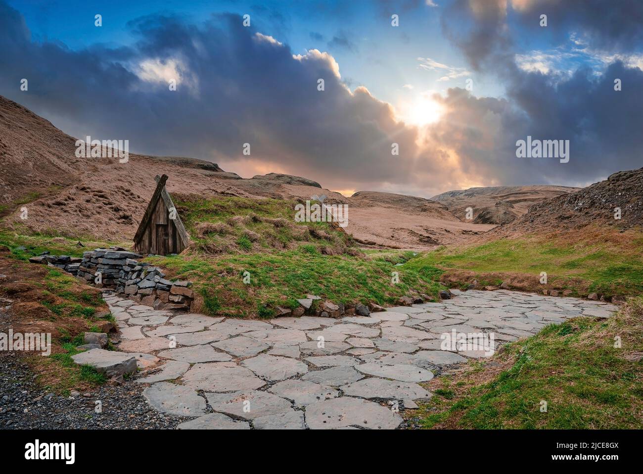 Beautiful turf house and geothermal hot spring in Hrunalaug against ...