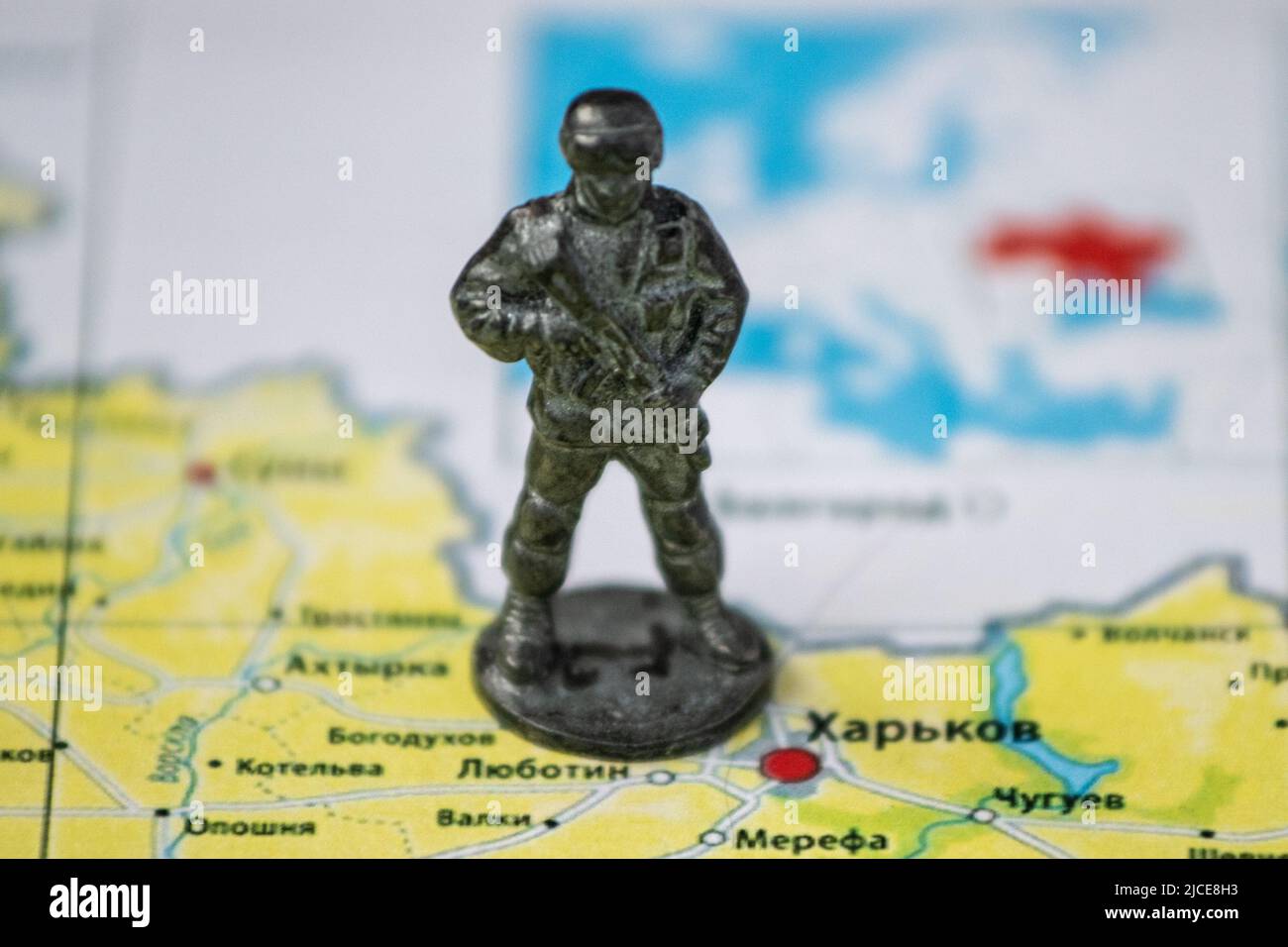 Metal figurine of a soldier on the background of the map of Ukraine ...