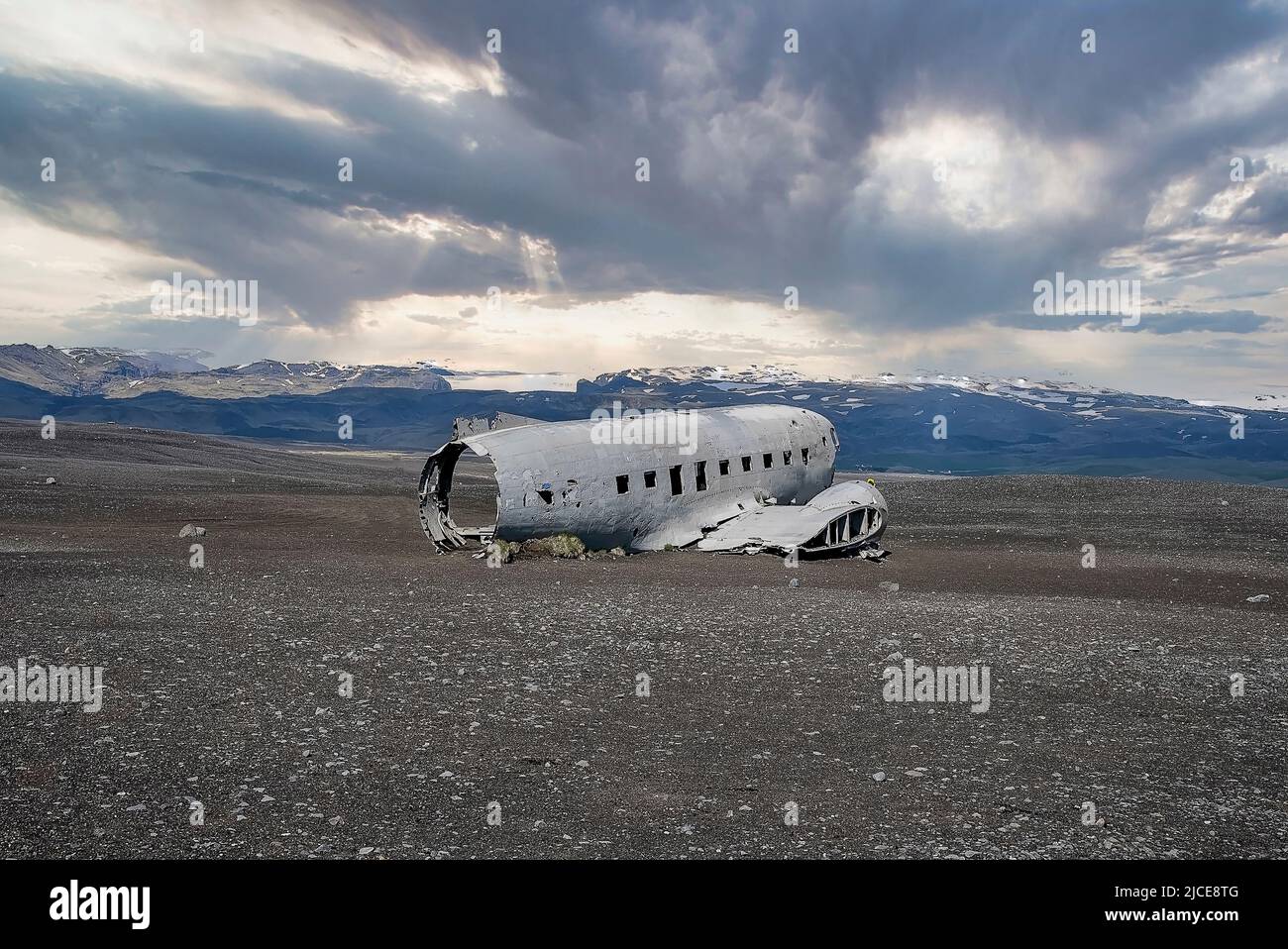 Broken airplane wreck at famous black beach in Solheimasandur against ...