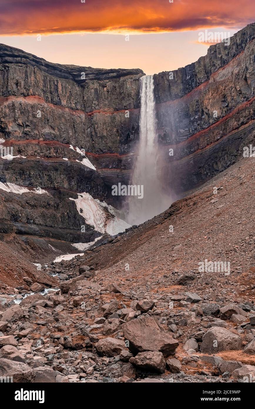 Powerful cascades of Hengifoss waterfall falling from mountains against ...