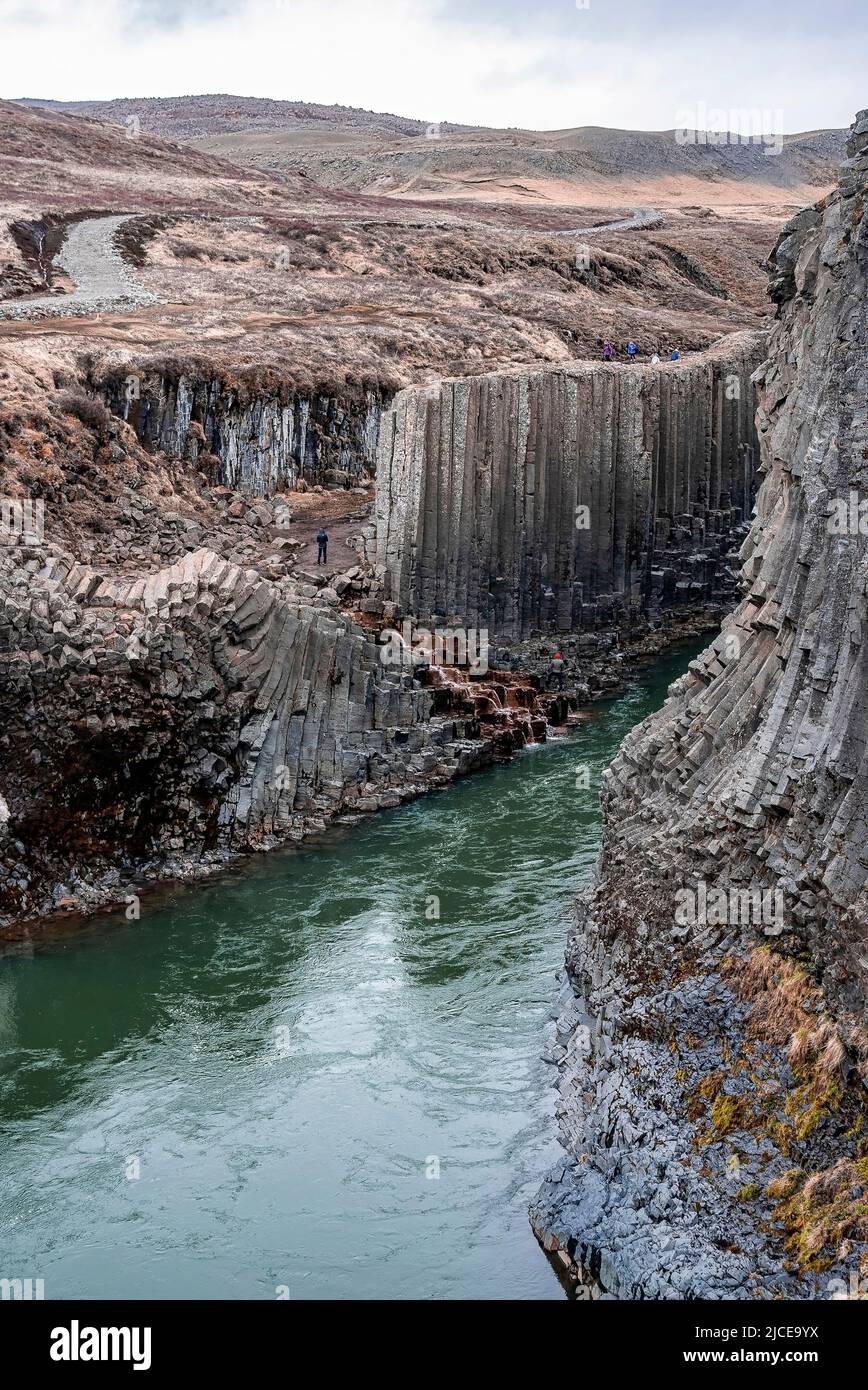 Beautiful view of stream flowing amidst basalt columns formation at ...
