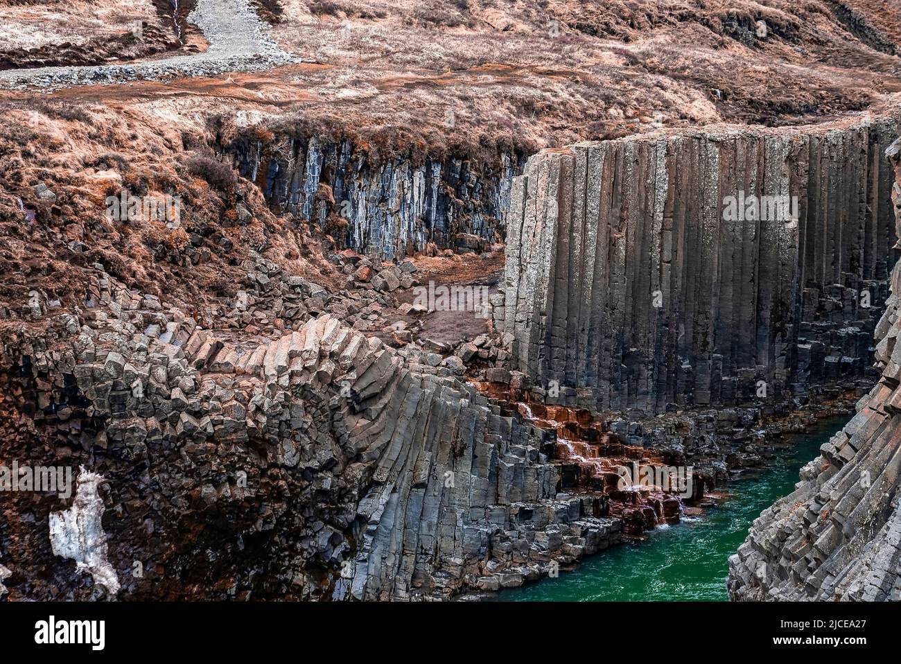 Scenic view of stream flowing amidst basalt columns formation at ...