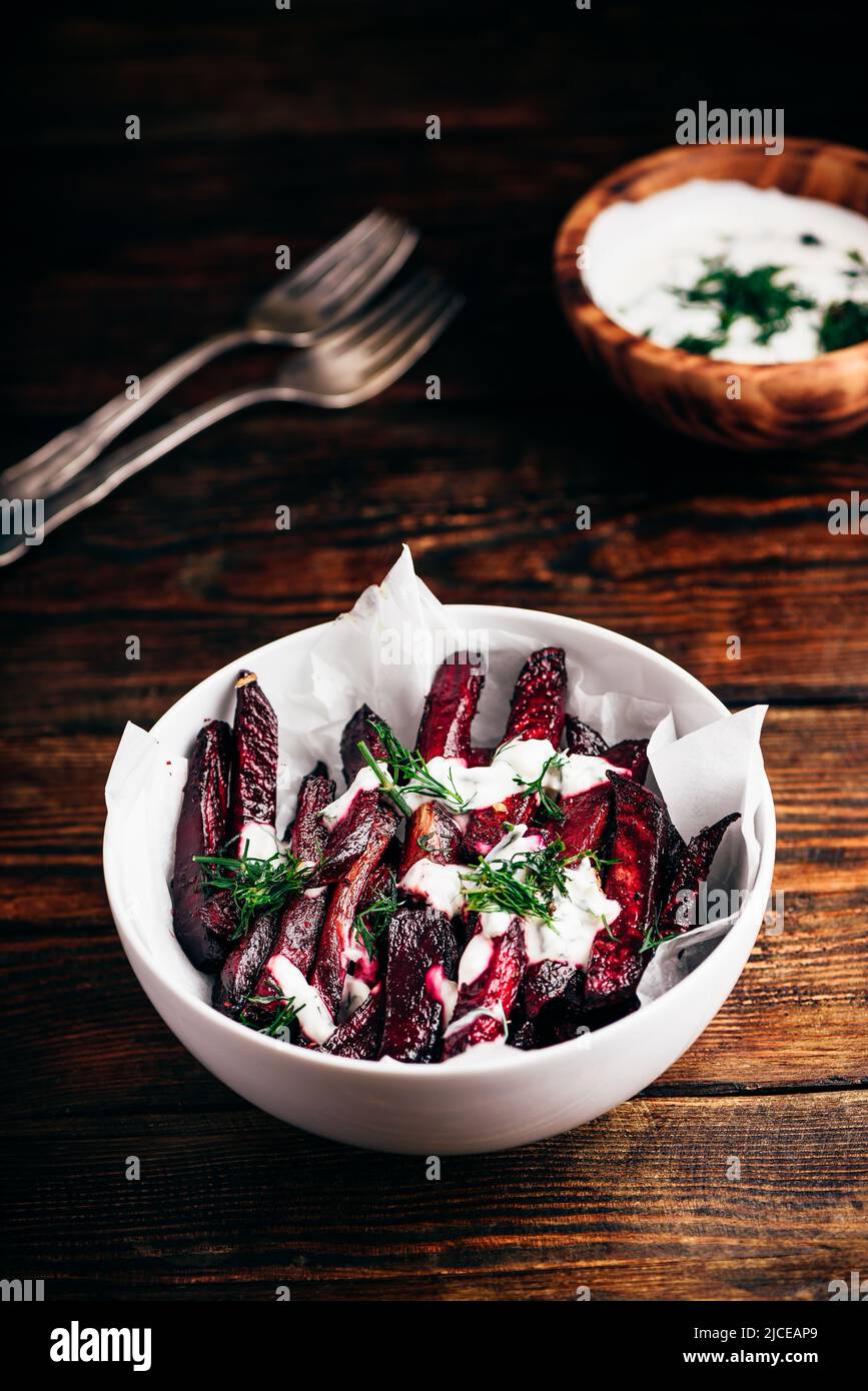 Oven baked beet fries with sour cream and dill dressing Stock Photo - Alamy