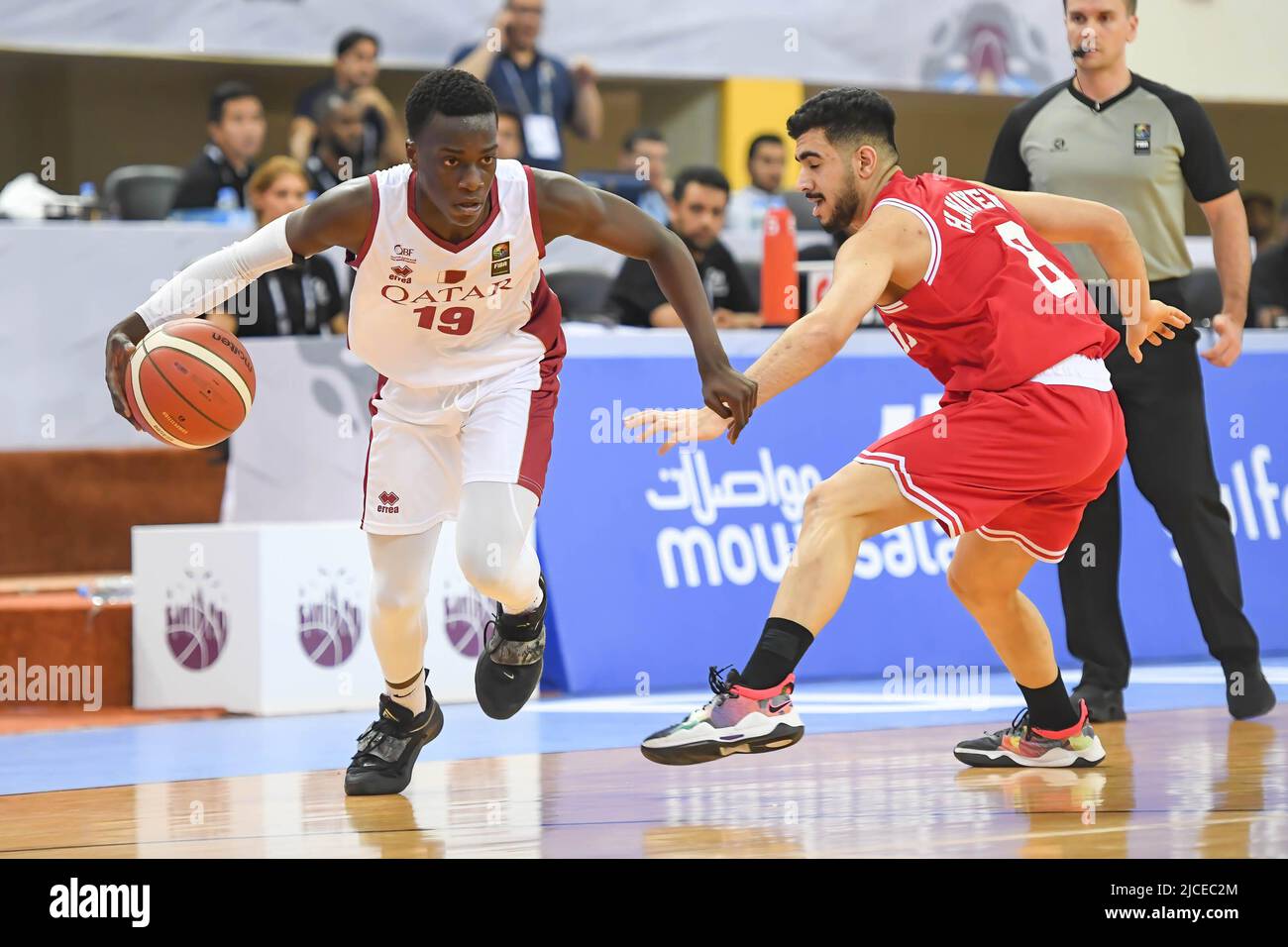 Doha, Qatar. 12th June, 2022. Moustapha Ndao (L) of Qatar Basketball team and Hasan Nayem (R) of ...