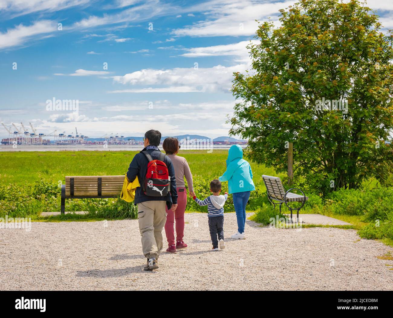 Family With children Walking Through Spring Park in sunny day. Asian ...