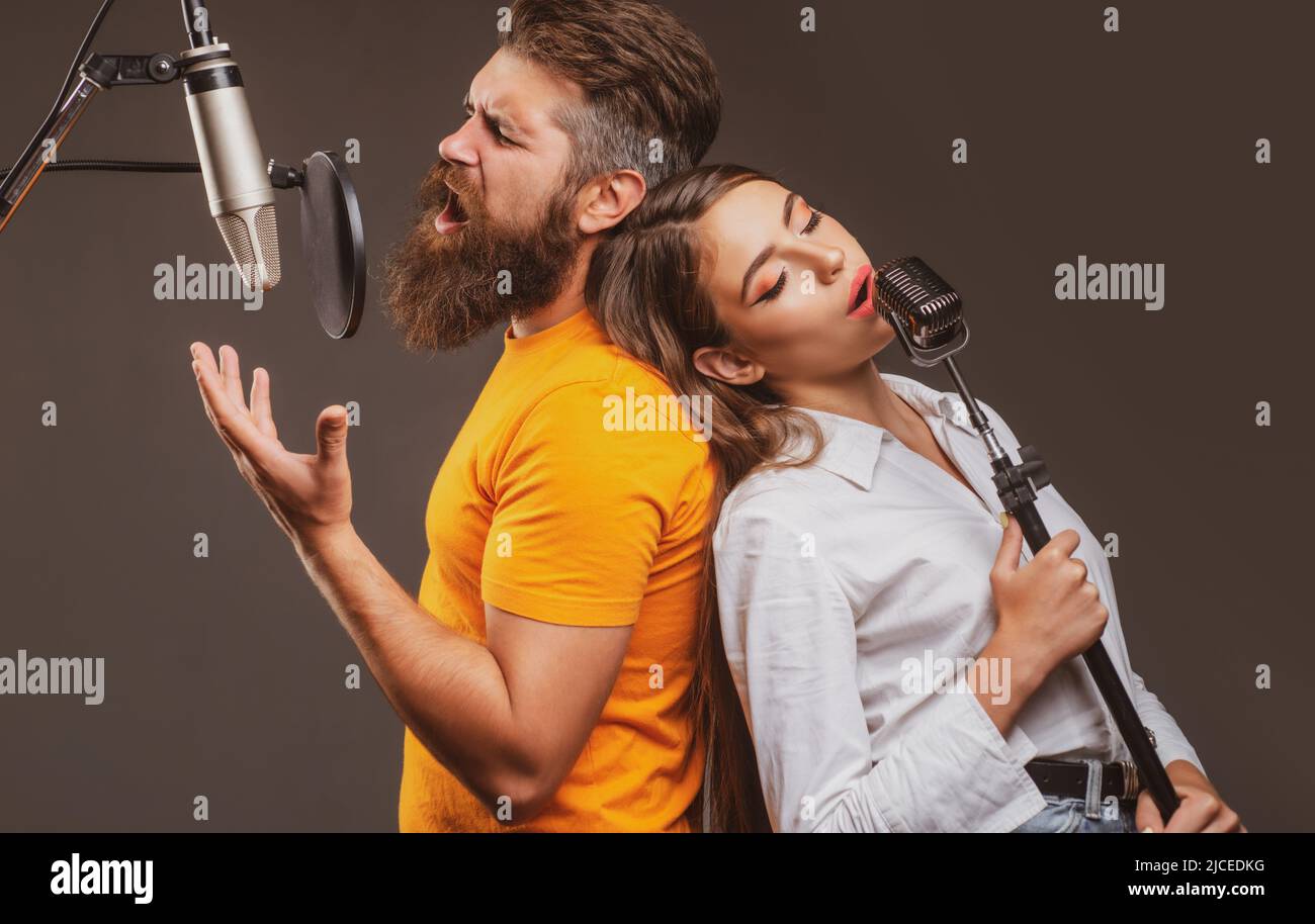 Couple duet with microphone singing song. Musician in music hall Stock ...