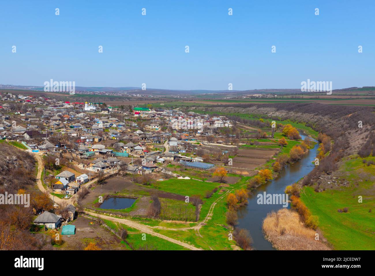 Rustic panorama view from above . Aerial view of riverside village ...