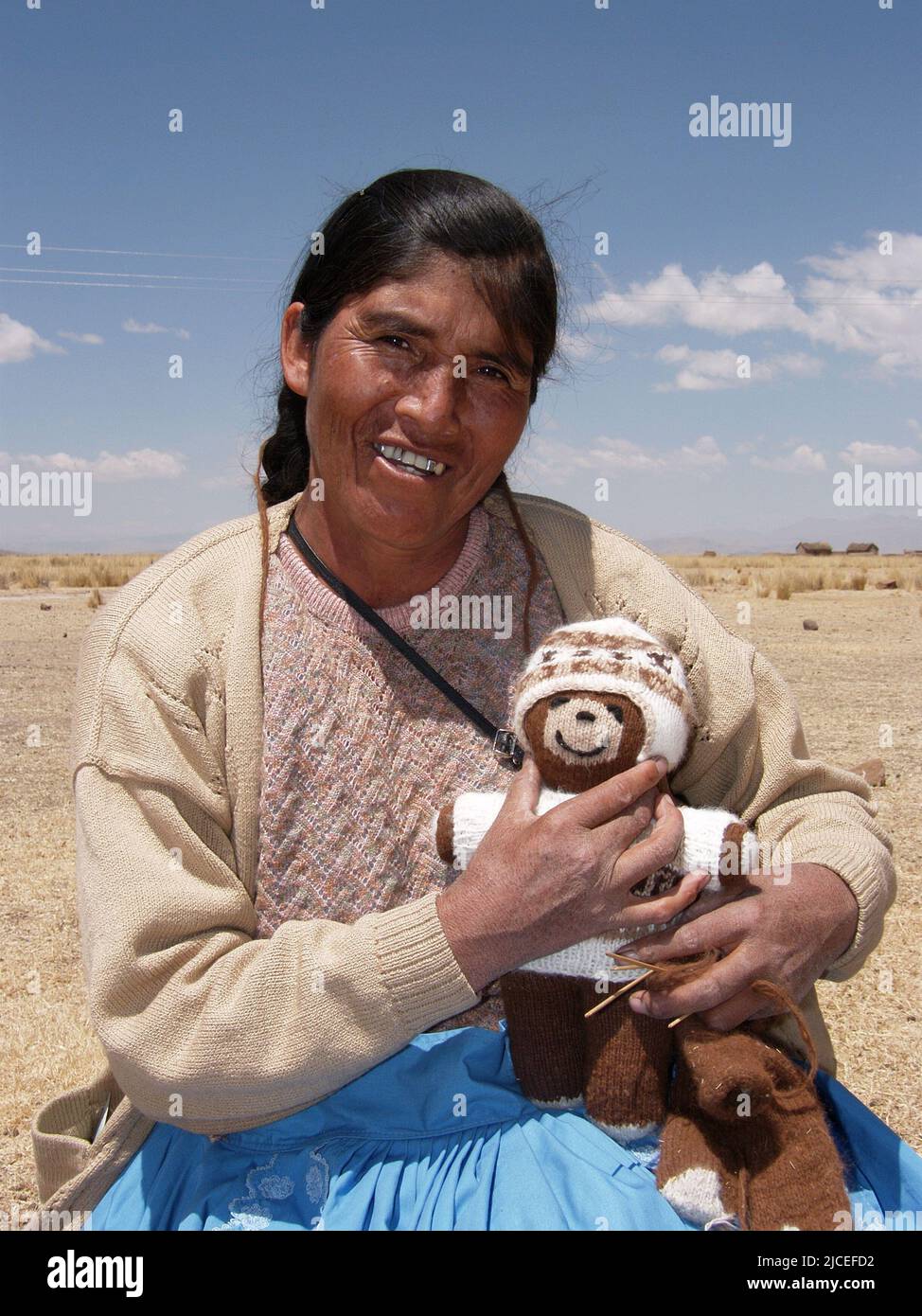 A peasant woman knitting in the prairie. Indigenous women from Juliaca ...