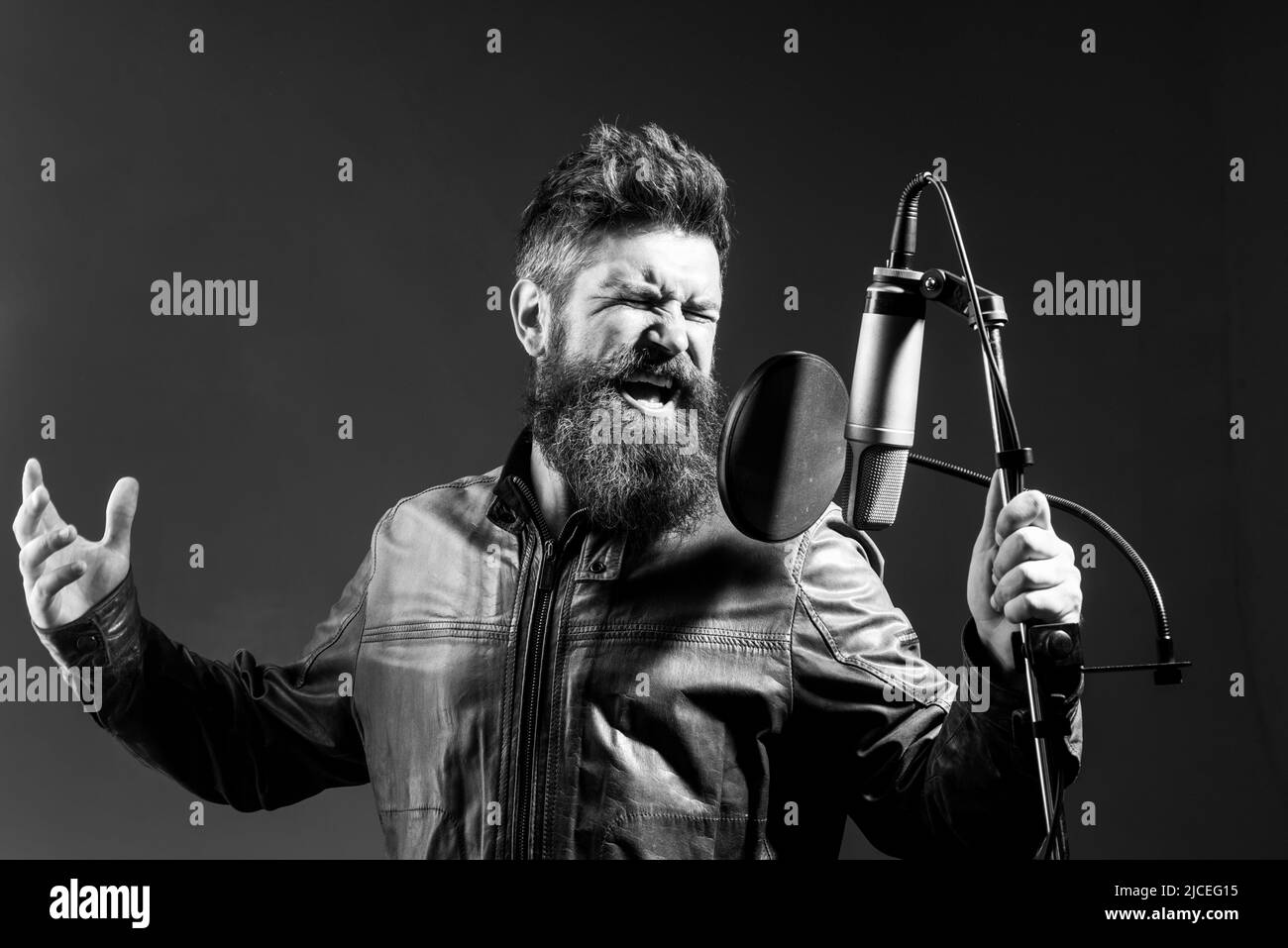 Singer singing rock. Expressive singer with microphone. Sound producer ...