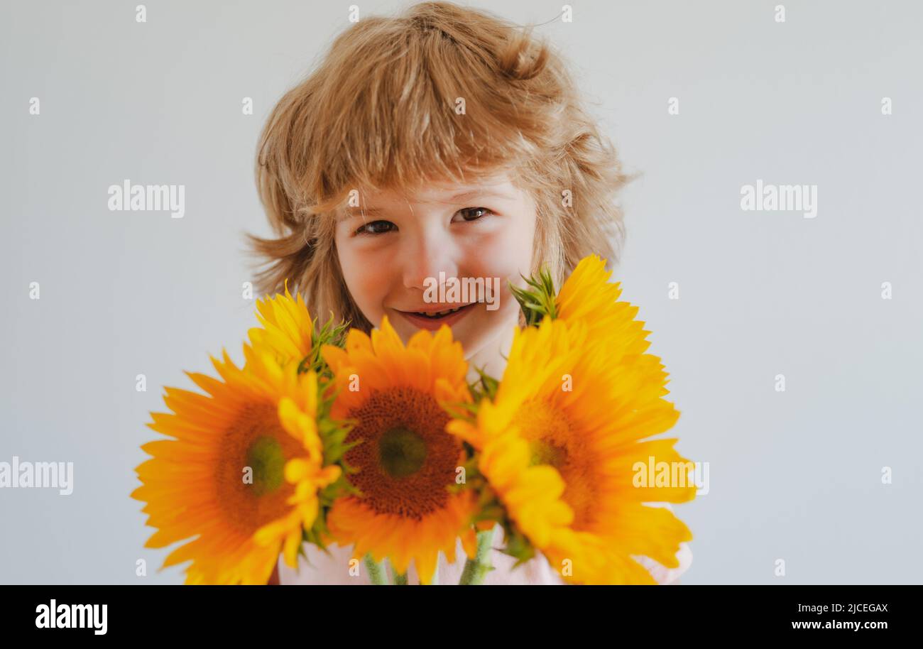Spring child with bouquet of sunflowers. Smiling kid with flowers. Cute ...