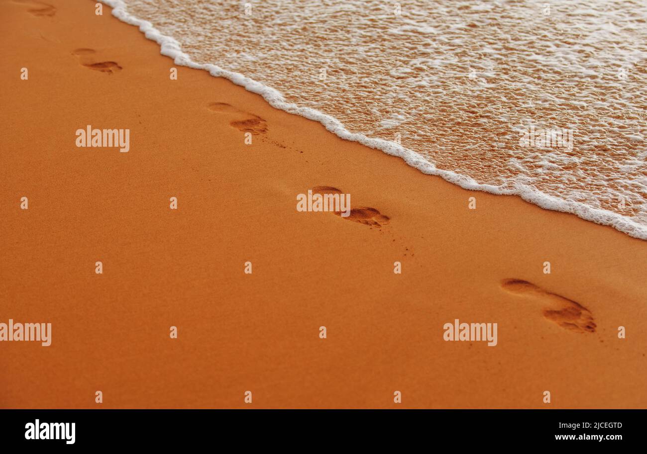 Footprints at golden sand, footsteps. Tropical beach with sea sand on ...